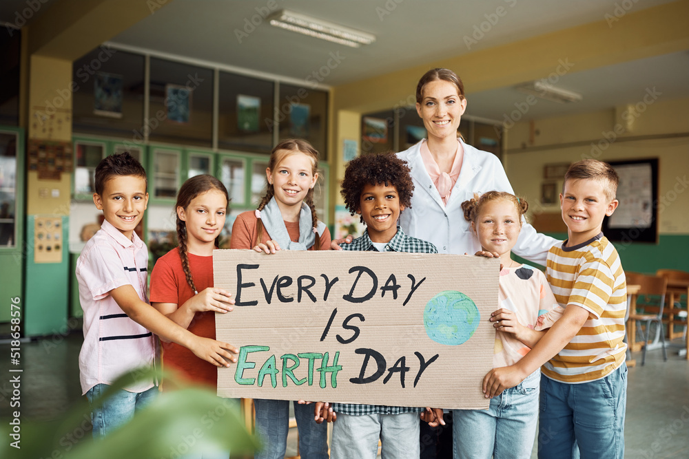 Science teacher her elementary students holding placard with 'every day ...