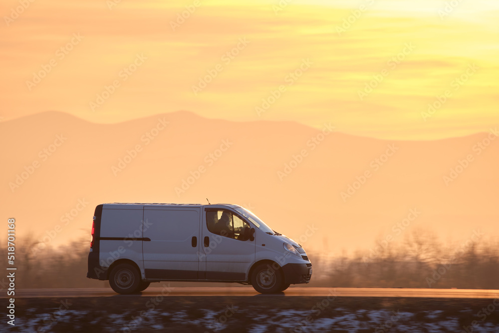 Small cargo van driving on highway hauling goods. Delivery ...