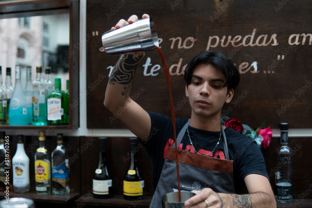 Latin bartender mixing a drink in an impressive way. Cocktail skills of ...
