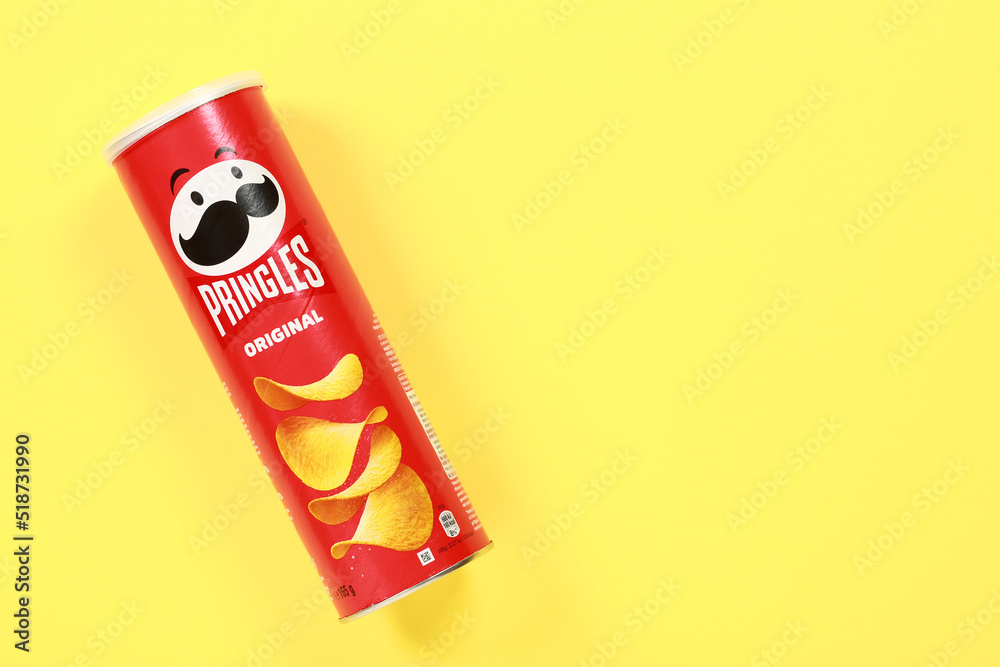 Pringles potato chips in a box on yellow background with copy space ...