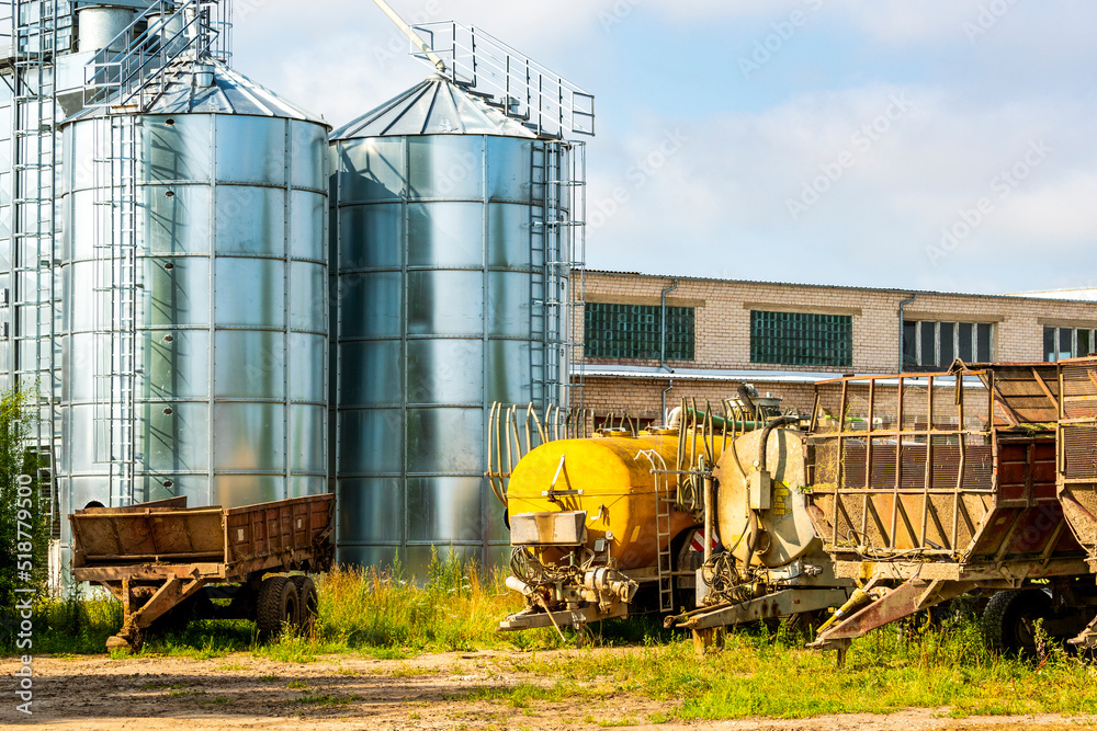 Farm yard with agricultural trailers, tanks and grain storage Stock ...