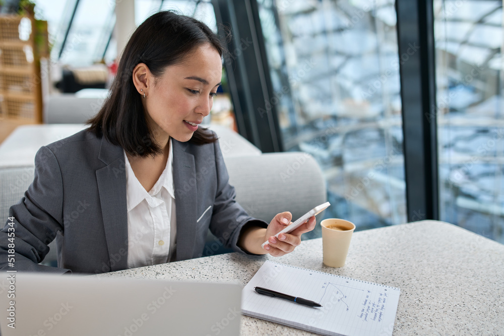 Young Asian business woman wearing suit working in modern office ...