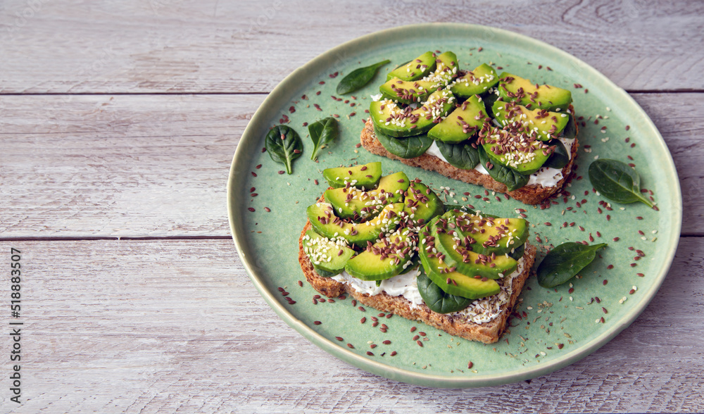 Toast with avocado, cottage cheese, spinach, sesame seeds, flax seeds ...
