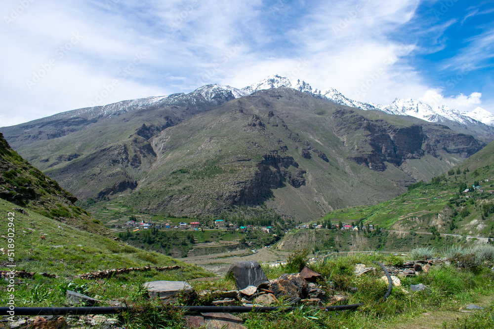 View of majestic mountains and greenery along with snow covered ...
