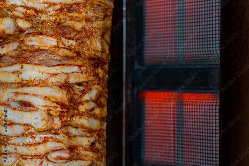 Doner kebab popular fast food cooked on a vertical rotisserie. Stock ...