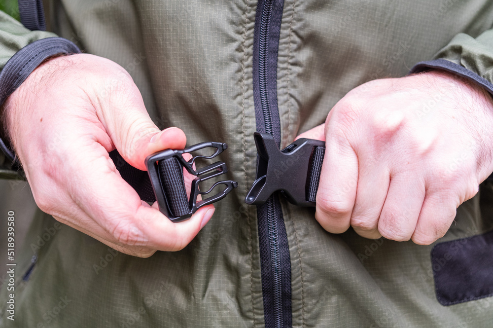 Fasten the waist belt of the backpack. Connect the latch with both ...