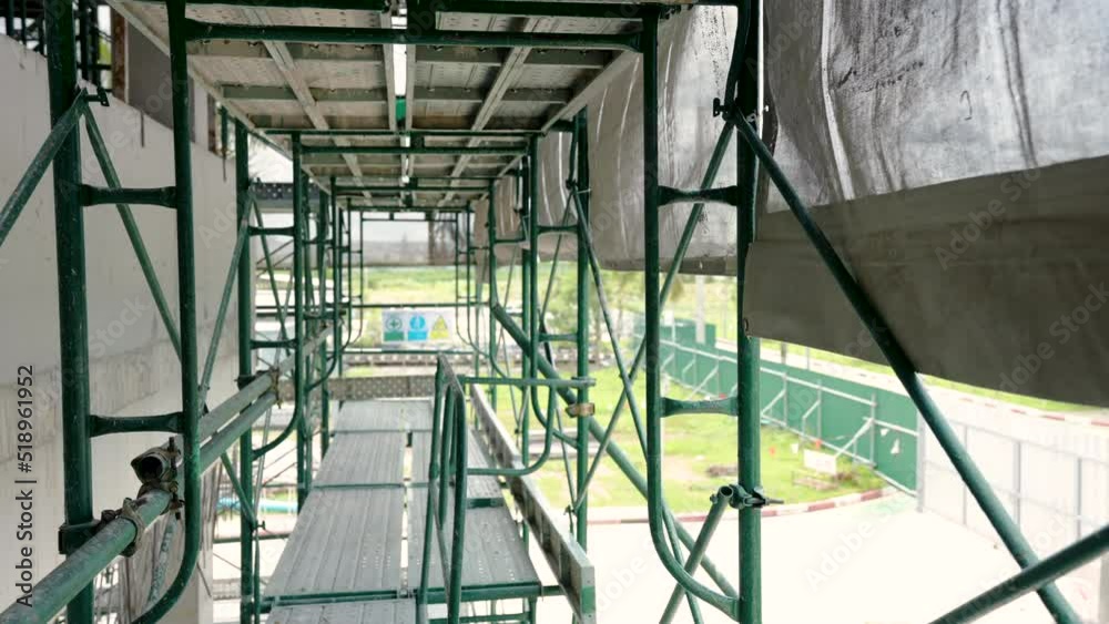 4K, A steel structure used as a scaffolding walkway for construction ...