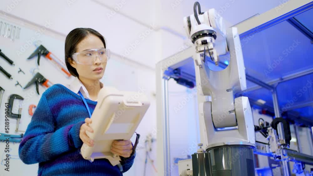 Lower view of pretty Asian female apprentice engineer in student ...
