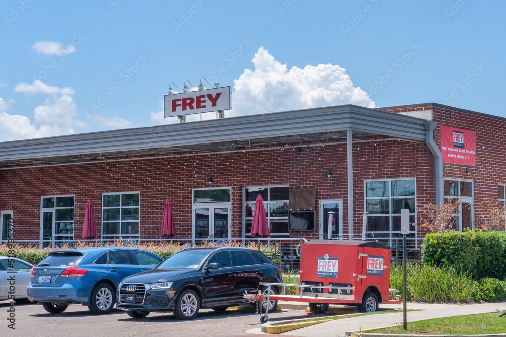 Front view of Frey Smoked Meat Company and smoker in parking lot in Mid ...
