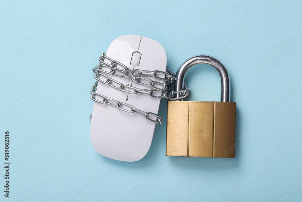PC mouse wrapped with a steel chain and a closed lock on a blue ...