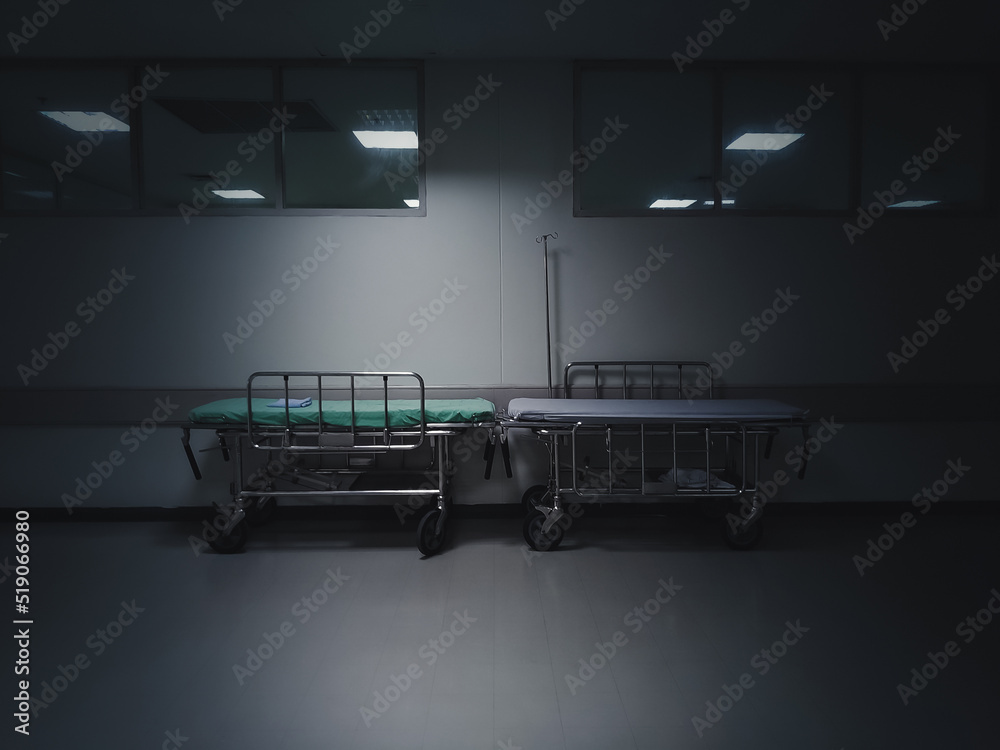 Hospital emergency bed. An empty bed in the dark corner of the ward ...