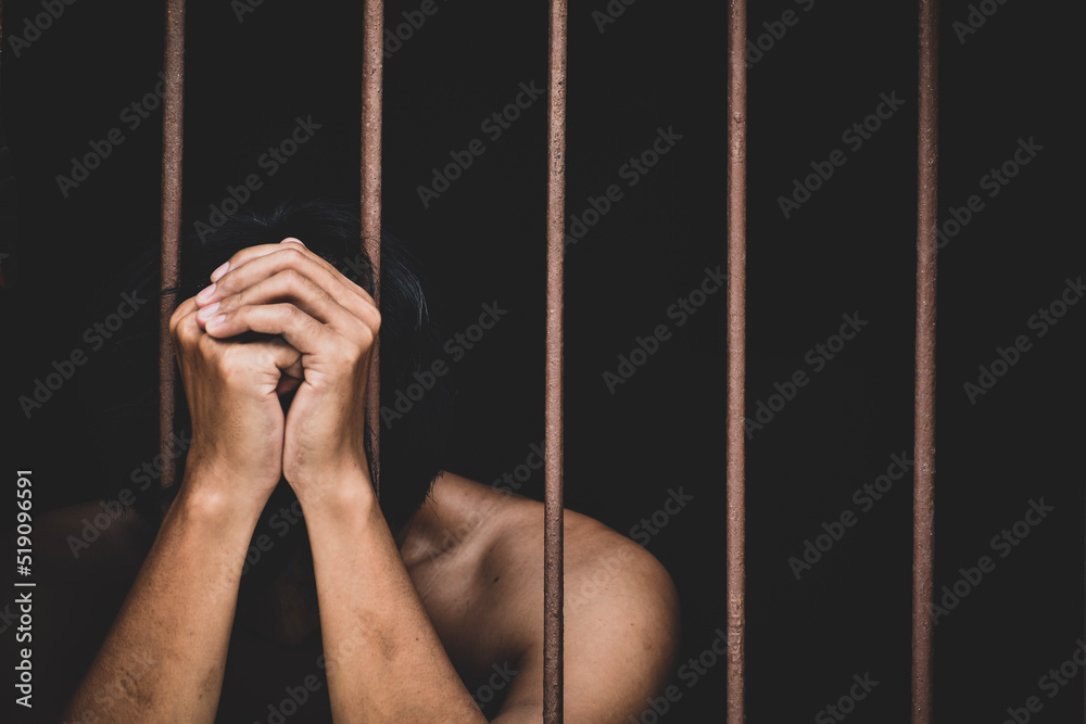 male inmate in prison lift hand to make a wish and pray on black ...