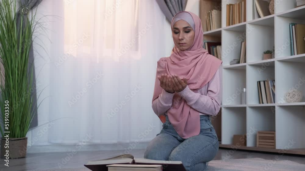 Koran praying. Faithful muslim. Islam culture. Calm focused woman in ...