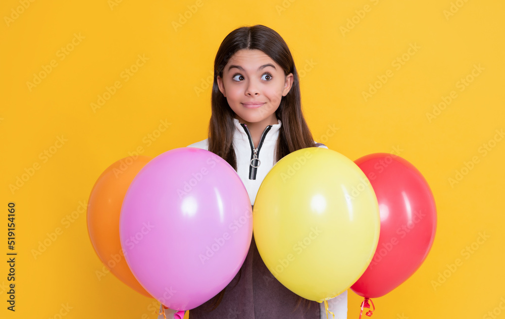 happy amazed kid with party colorful balloons on yellow background ...
