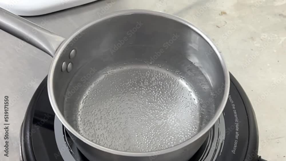 Vídeo do Stock: Hot water boiling on electric cooktop, pastry chef ...
