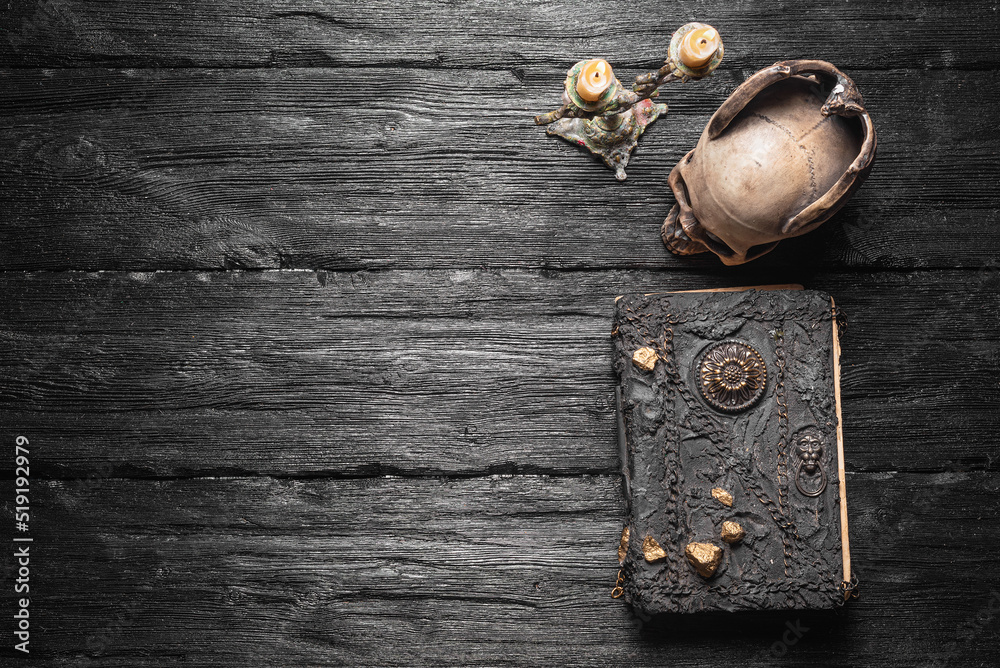 Old spell magic book and burning candle on the wooden table flat lay ...