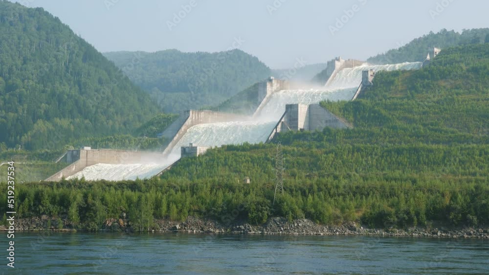 Coastal spillway of Sayano-Shushenskaya Dam on Yenisei River surrounded ...