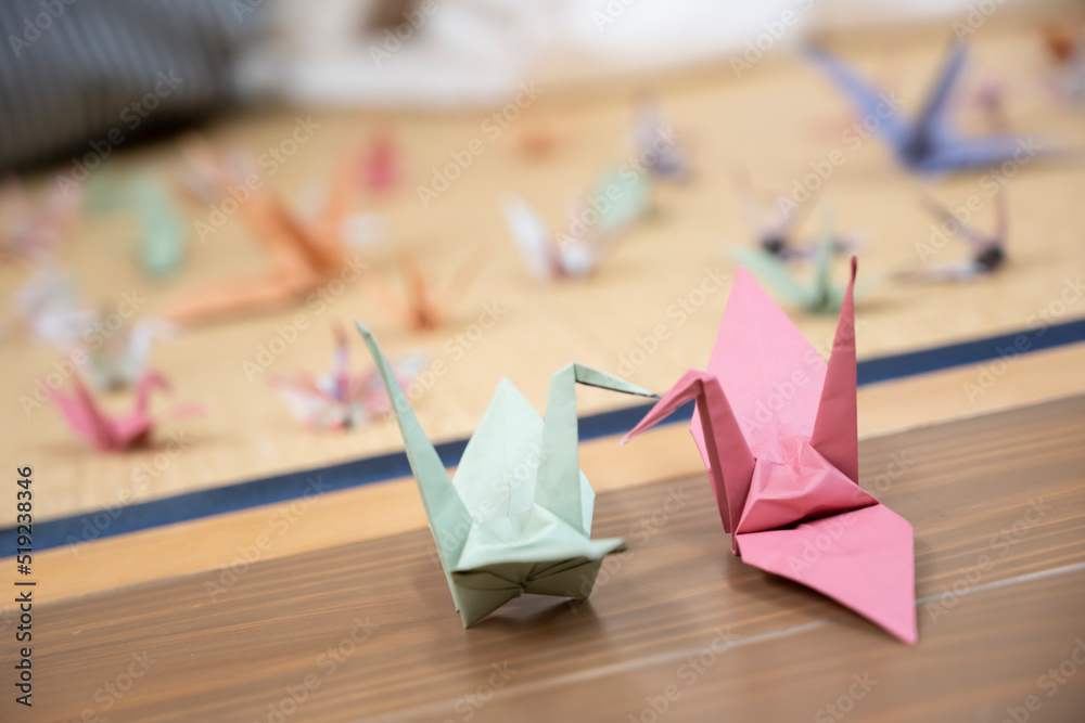 Two origami cranes that stick the beaks together Stock Photo | Adobe Stock