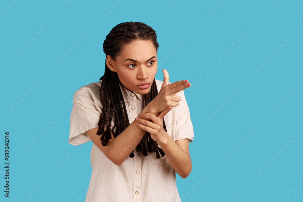 Portrait of woman with black dreadlocks pointing finger gun, aiming and ...