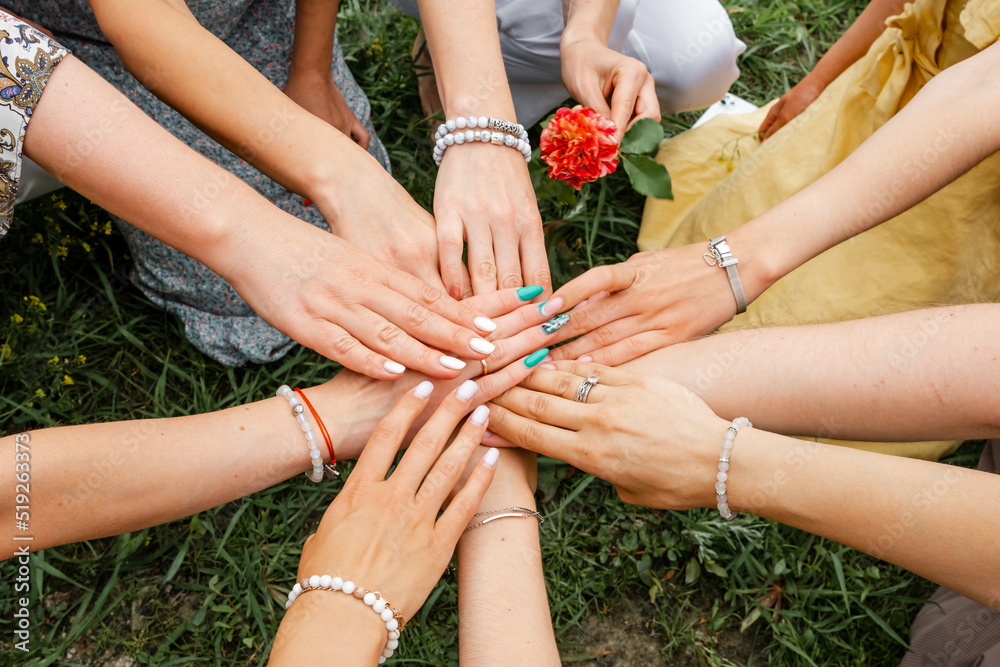 Multiracial group of friends in stack. Teamwork. Female models joining ...