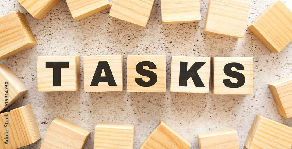 The word TASKS consists of wooden cubes with letters, top view on a ...