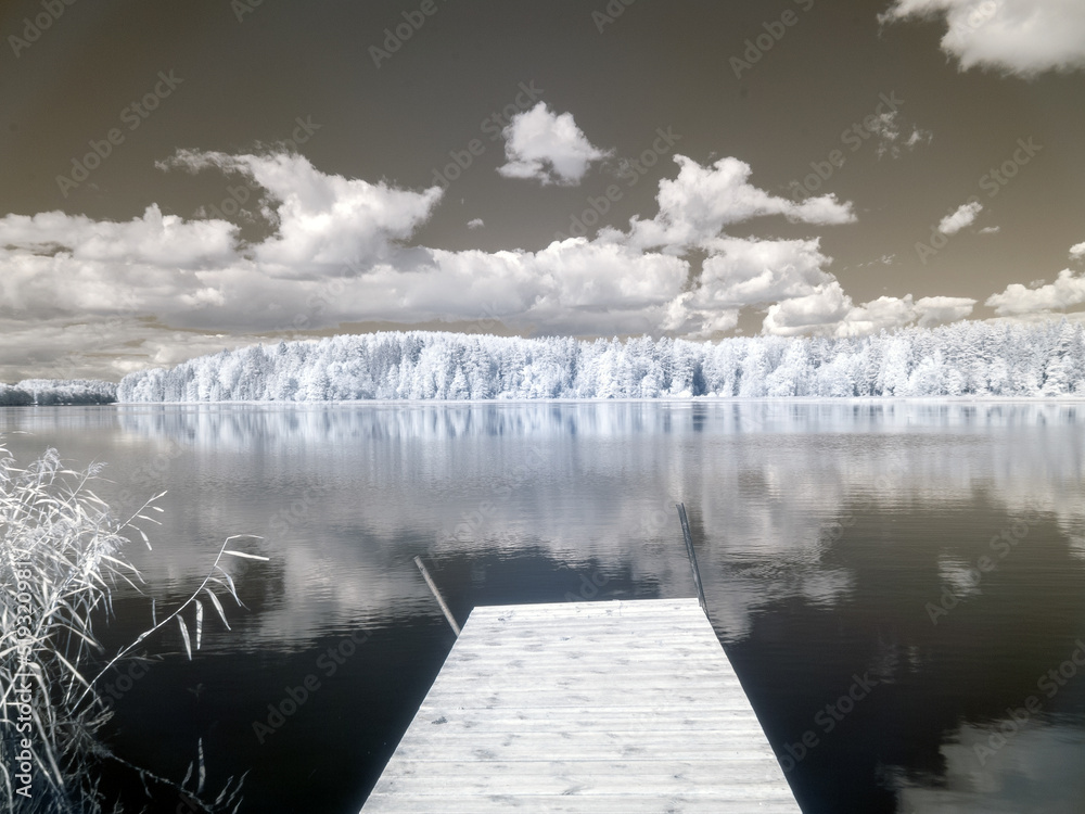 infrared surreal landscape, lake with wooden footbridge, infrared photo ...