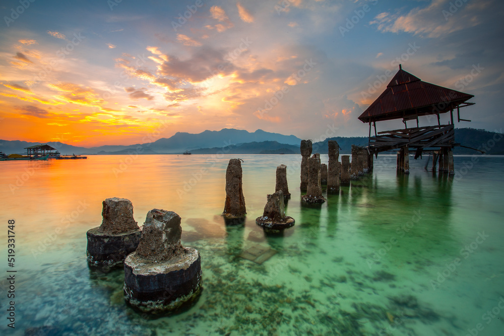 stunning sunset on the beach Tanjung Putus Lampung. building on a clear ...