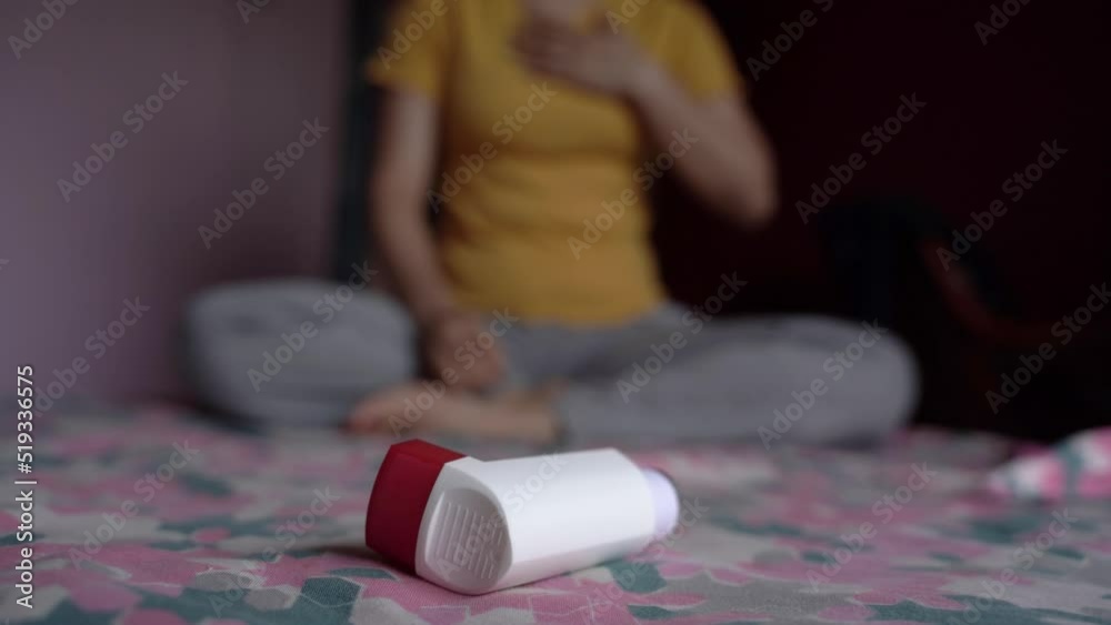 Asthmatic patient catching inhaler having an asthma attack. Young woman ...
