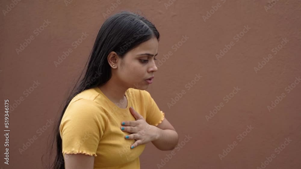 Asthmatic patient catching inhaler having an asthma attack. Young woman ...