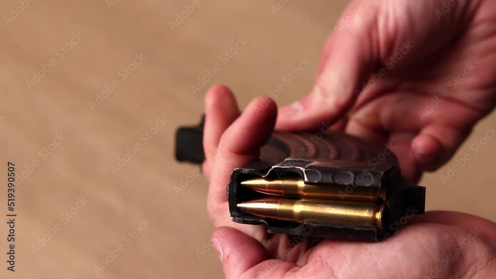 Male hands with Kalashnikov assault rifle magazine with cartridges ...