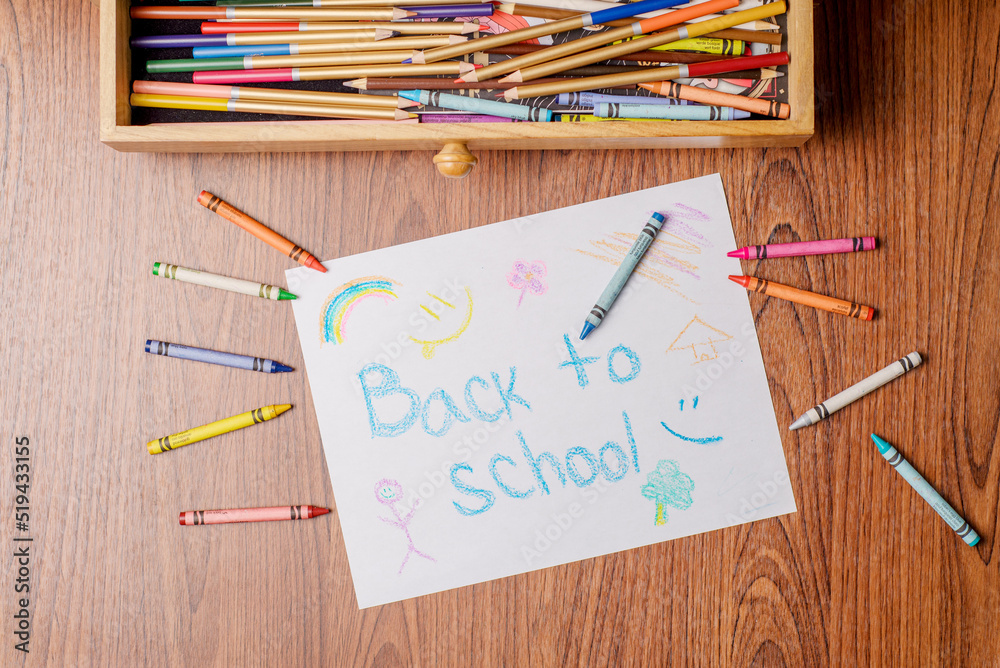 Foto de Colored pencils and crayons in disorder on a wood table. Group ...