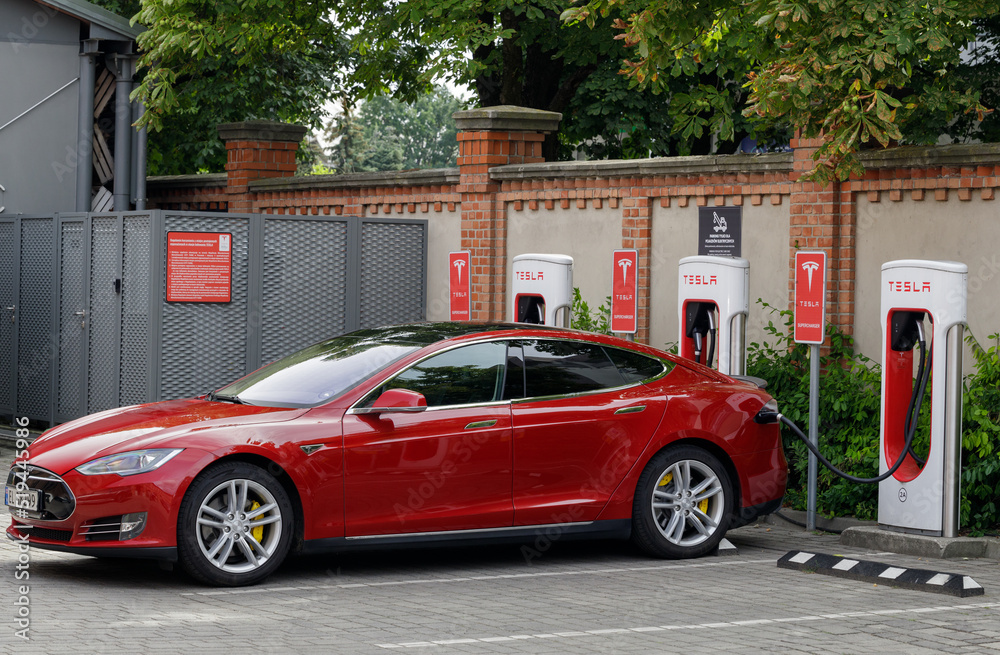 Poznan, Poland. 26 Jul 2022: Red Tesla cars charging at a Tesla ...