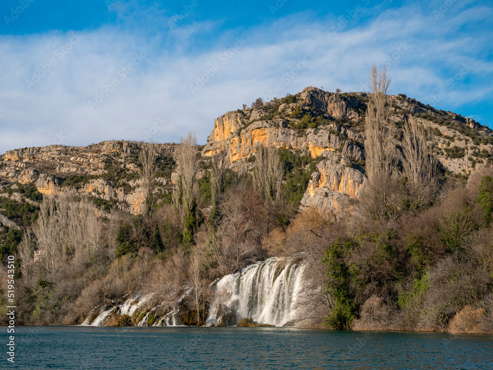 Amazing waterfall under the limestone cliff joining with beautiful Krka ...