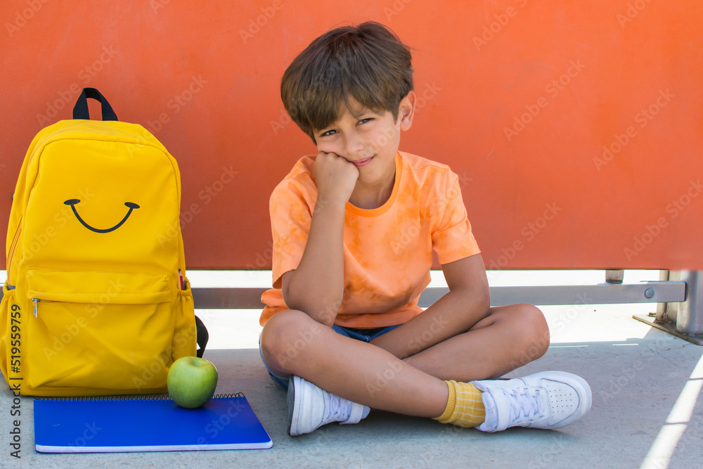 Little boy smiling on the first day of school. Little boy with yellow ...