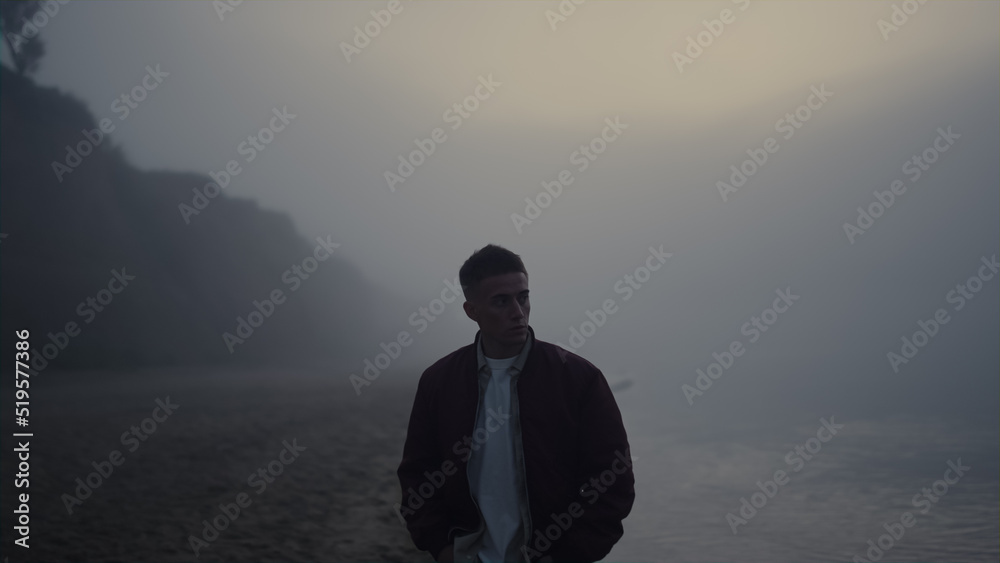 Sad man walking sea shore. Upset guy feeling lonely. Model looking ...