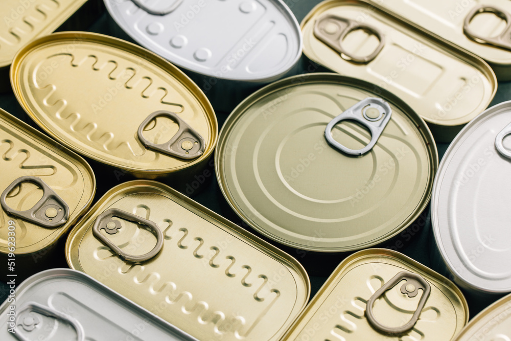 Row of cans on a blue background Stock Photo | Adobe Stock