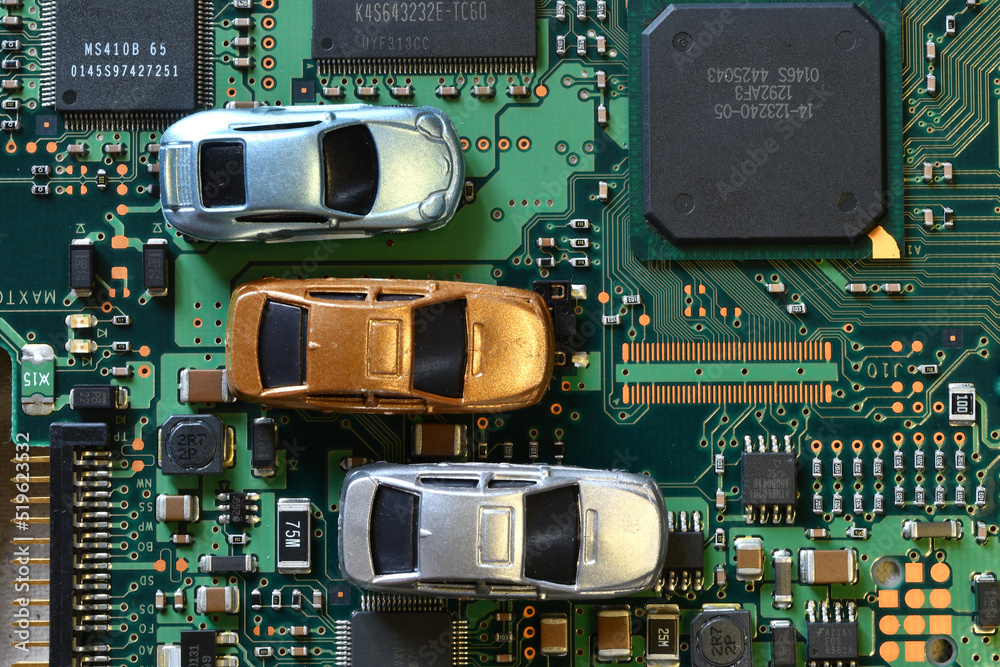 Toy cars on electronic board and microchip. Conceptual image for ...