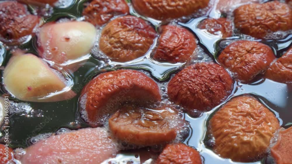 Boiled fruits in boiling water, preparation of fruit drink. Little ...