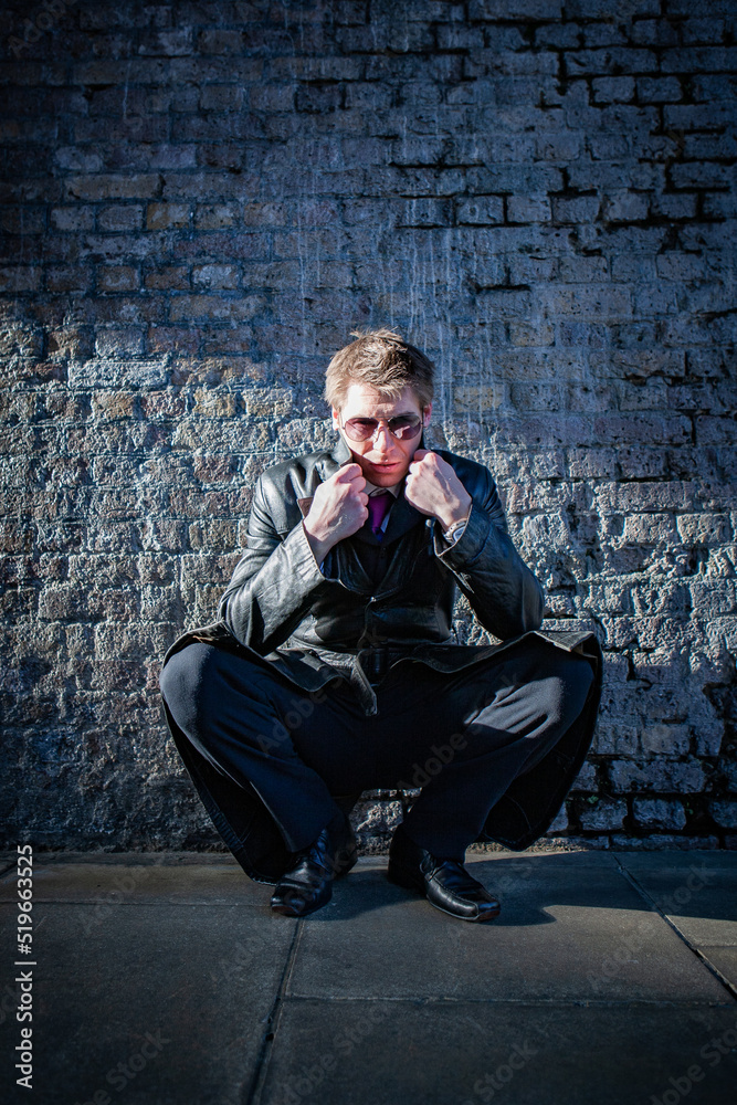 Undercover; surveillance. A spy hiding in the shadows is revealed by a ...