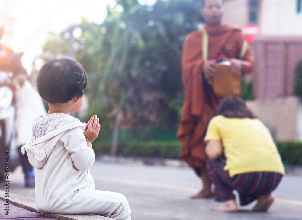 Little girl sitting praying who make merit worship a monk on the ...