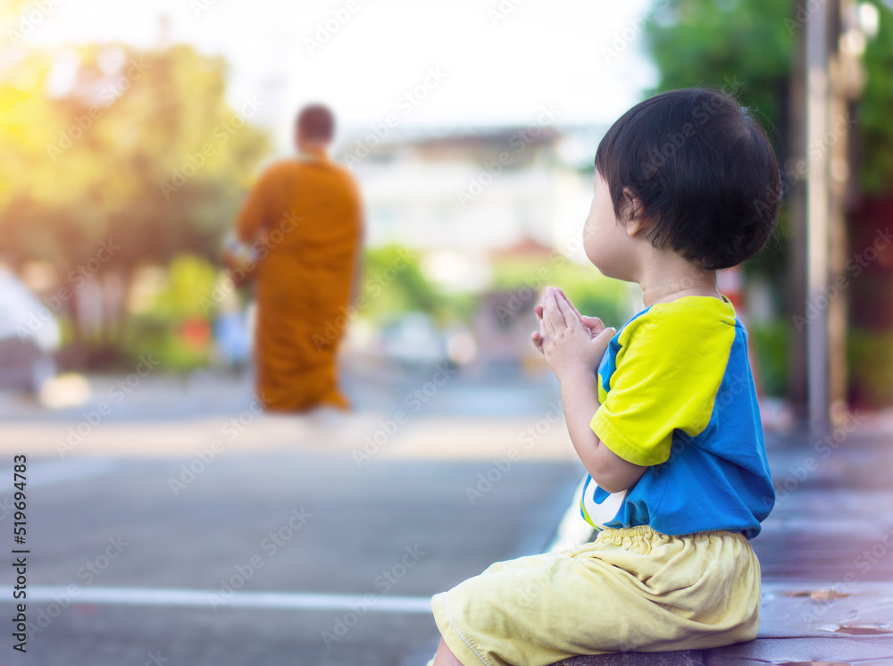 Little girl sitting praying who make merit worship a monk on the ...
