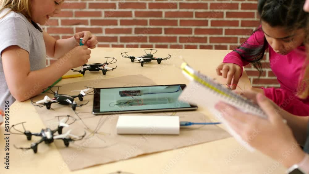 Science students building, testing and designing drones, batteries and ...