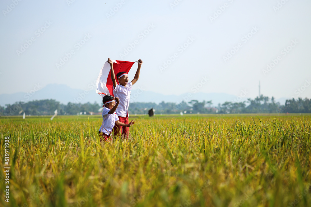 Indonesian school students wearing uniform are raising their hands ...