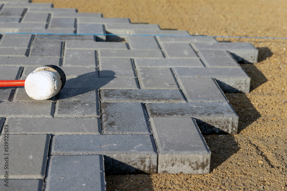 The master lays concrete pavers on a gravel-sand base. Stock Photo ...