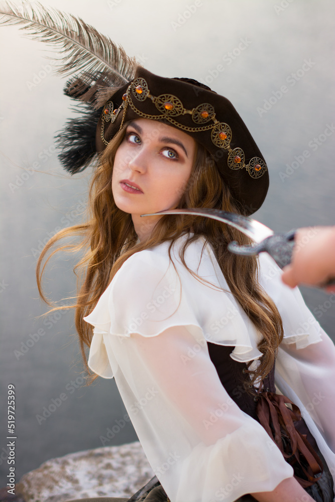 Vivid color photo of a beautiful pirate girl in a hat with a feather ...