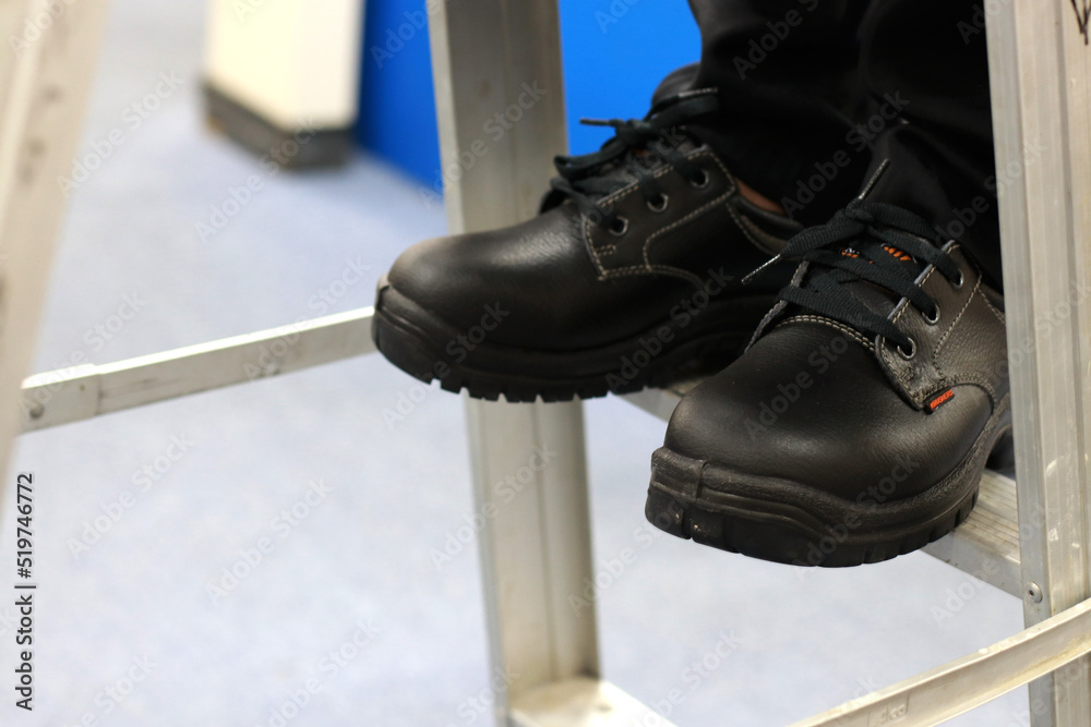 Safety shoes are made of leather to protect the feet of workers from ...