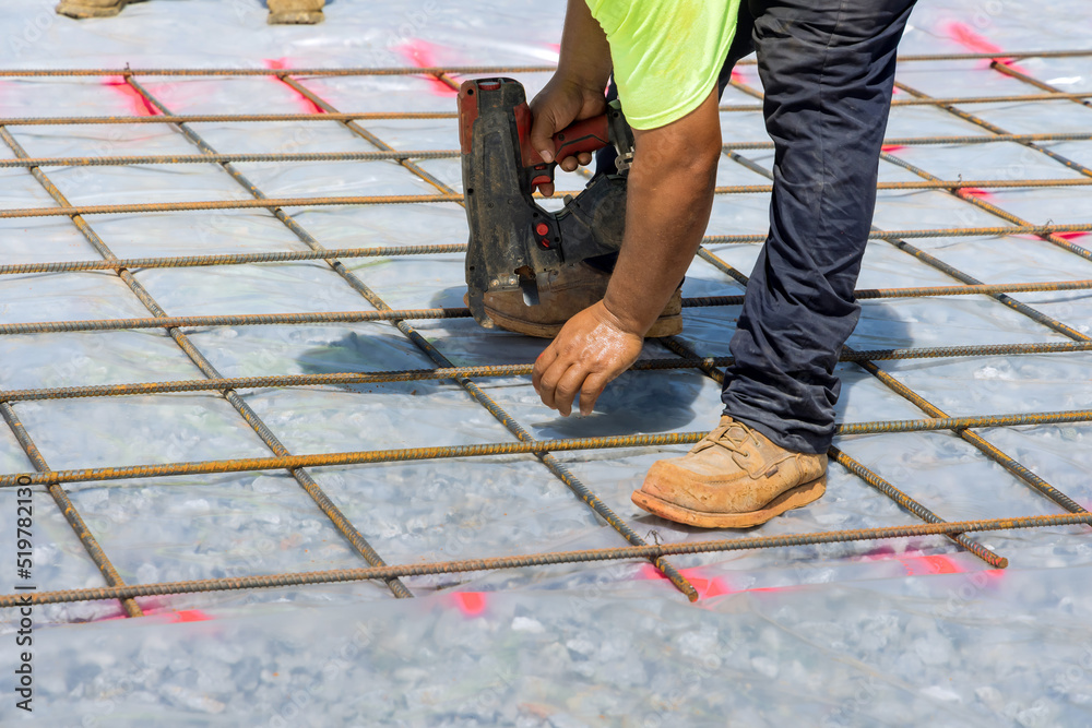 Construction worker twist steel bars with wire rod reinforcement into ...