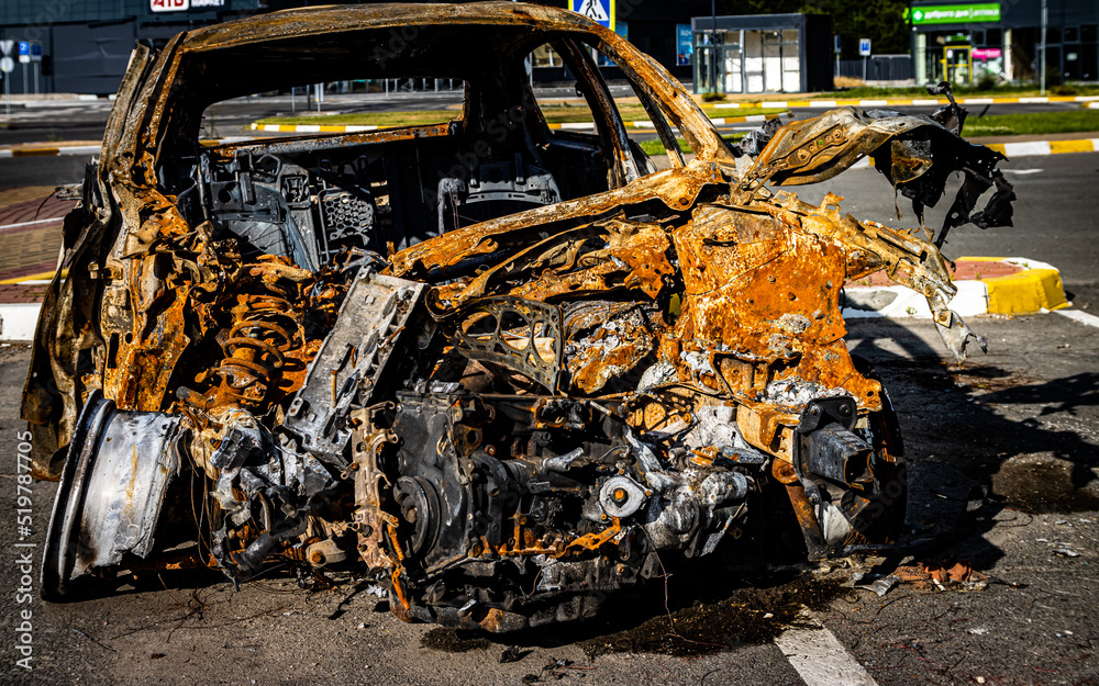 Bucha, Ukraine - May 22, 2022: a car burned in the bombed-out yard ...