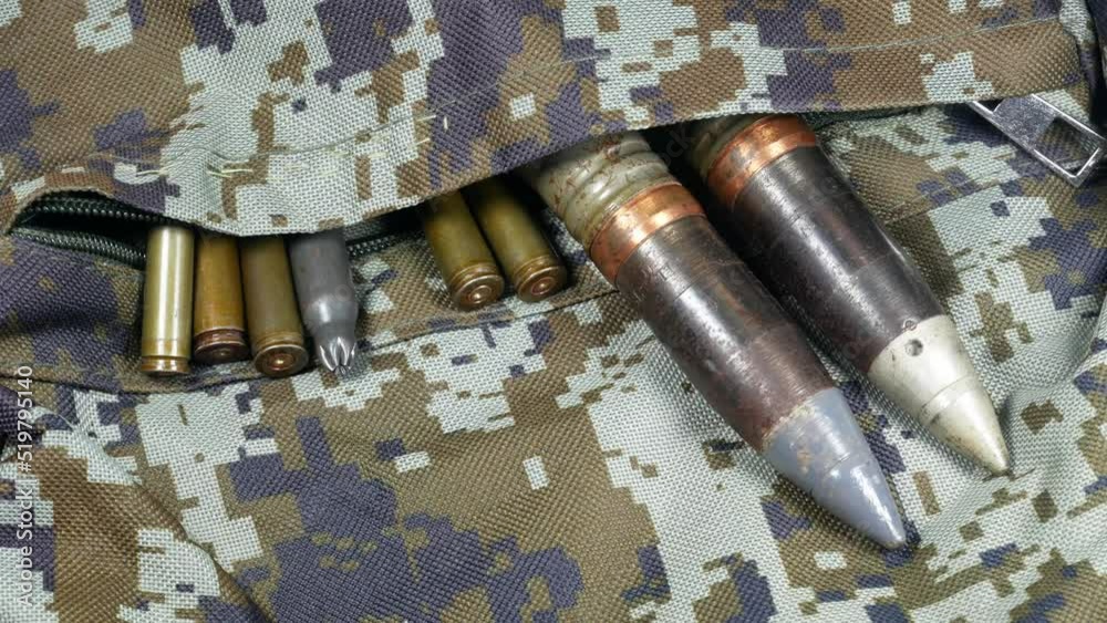 Soldier hold Bullets, shells, cartridges and projectiles on khaki ...