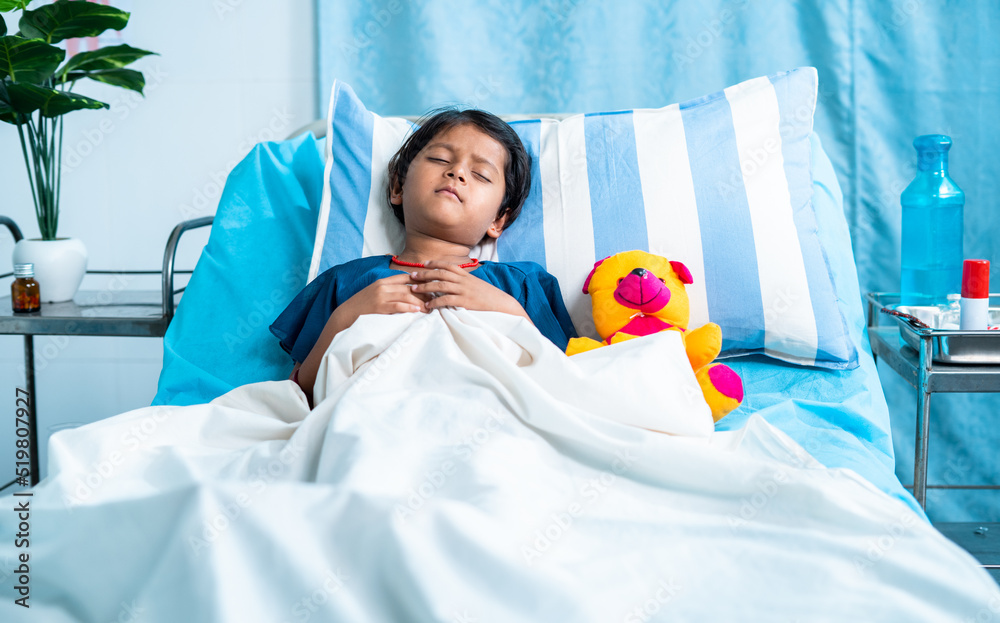 Sick girl child with teddy bear sleeping on bed at hospital - concept ...